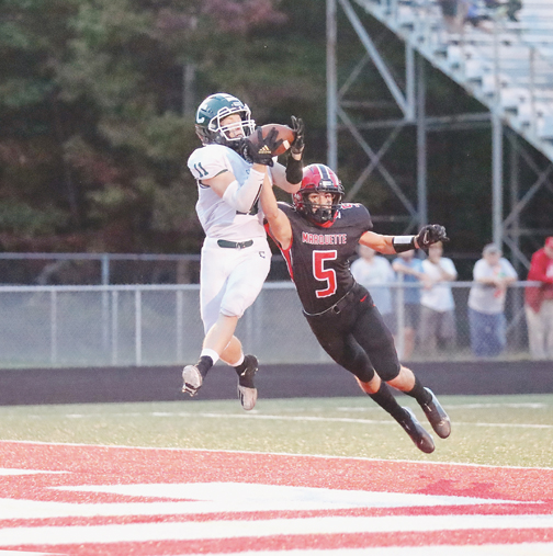 Working to mesh: Marquette Redmen football team brings athletic talent ...